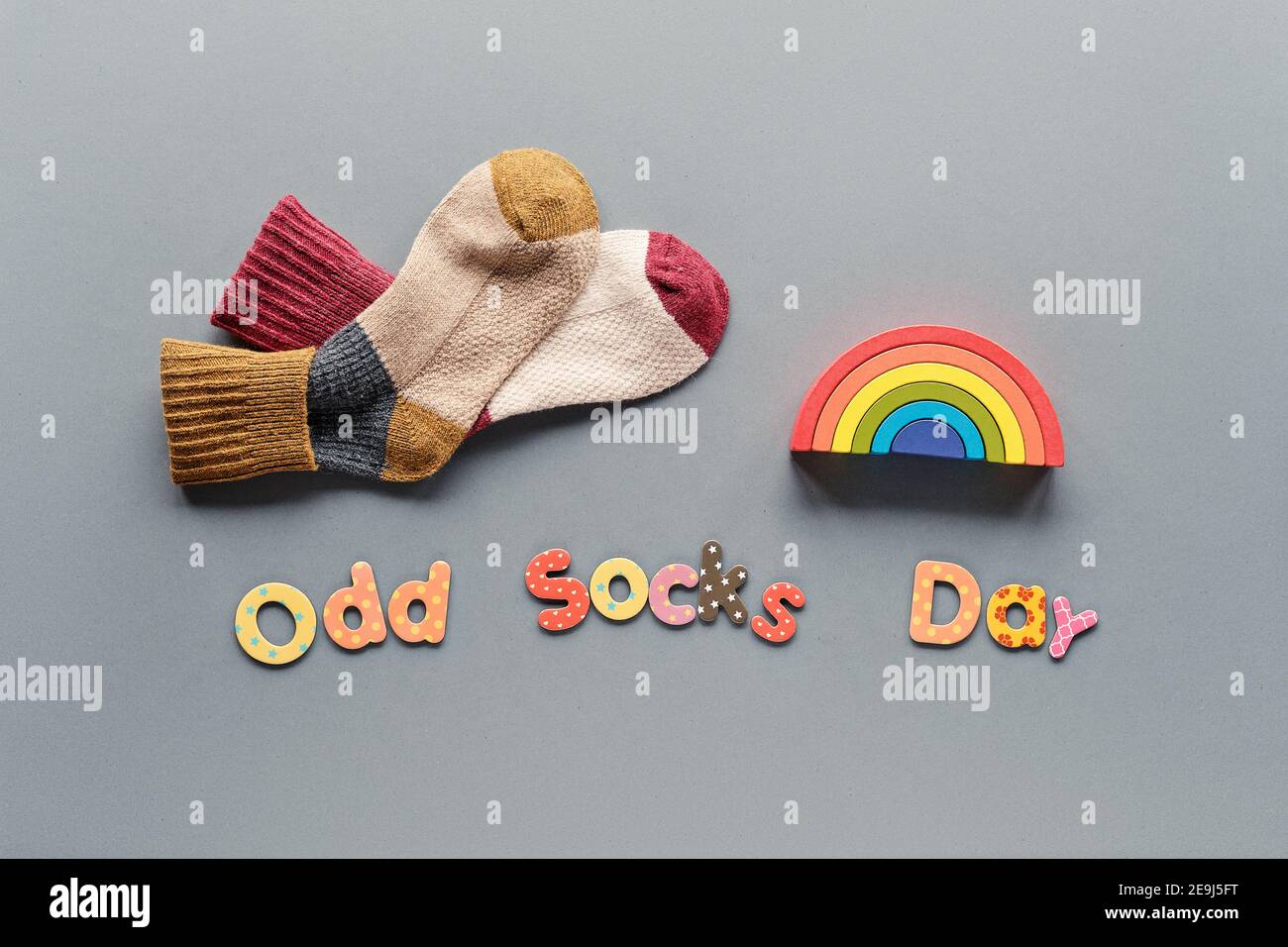 Odd Socks Day. Pair of mismatched school socks. Wooden rainbow. Social ...
