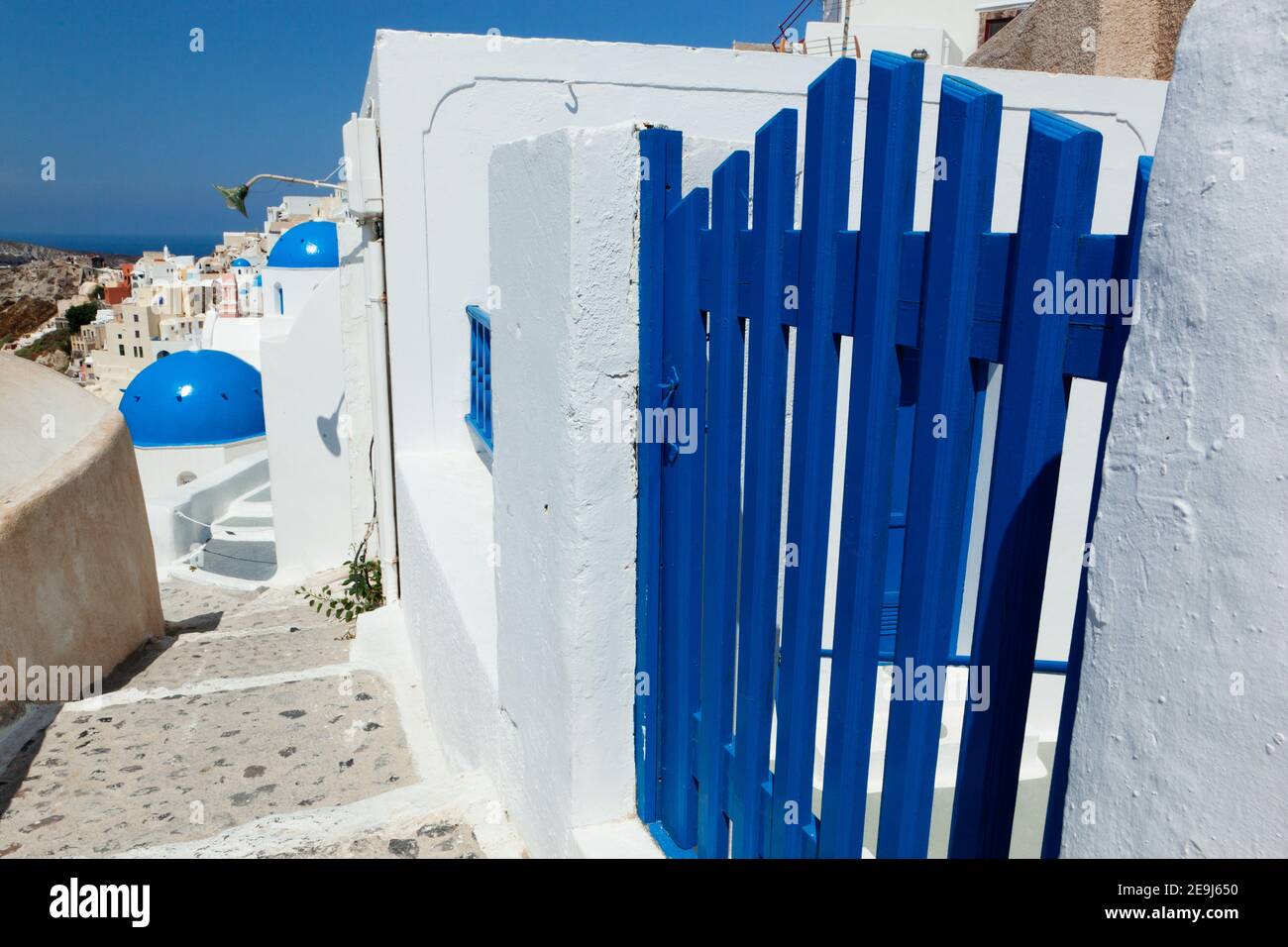 Santorini, Greece Blue gate along path to traditional whitewashed ...