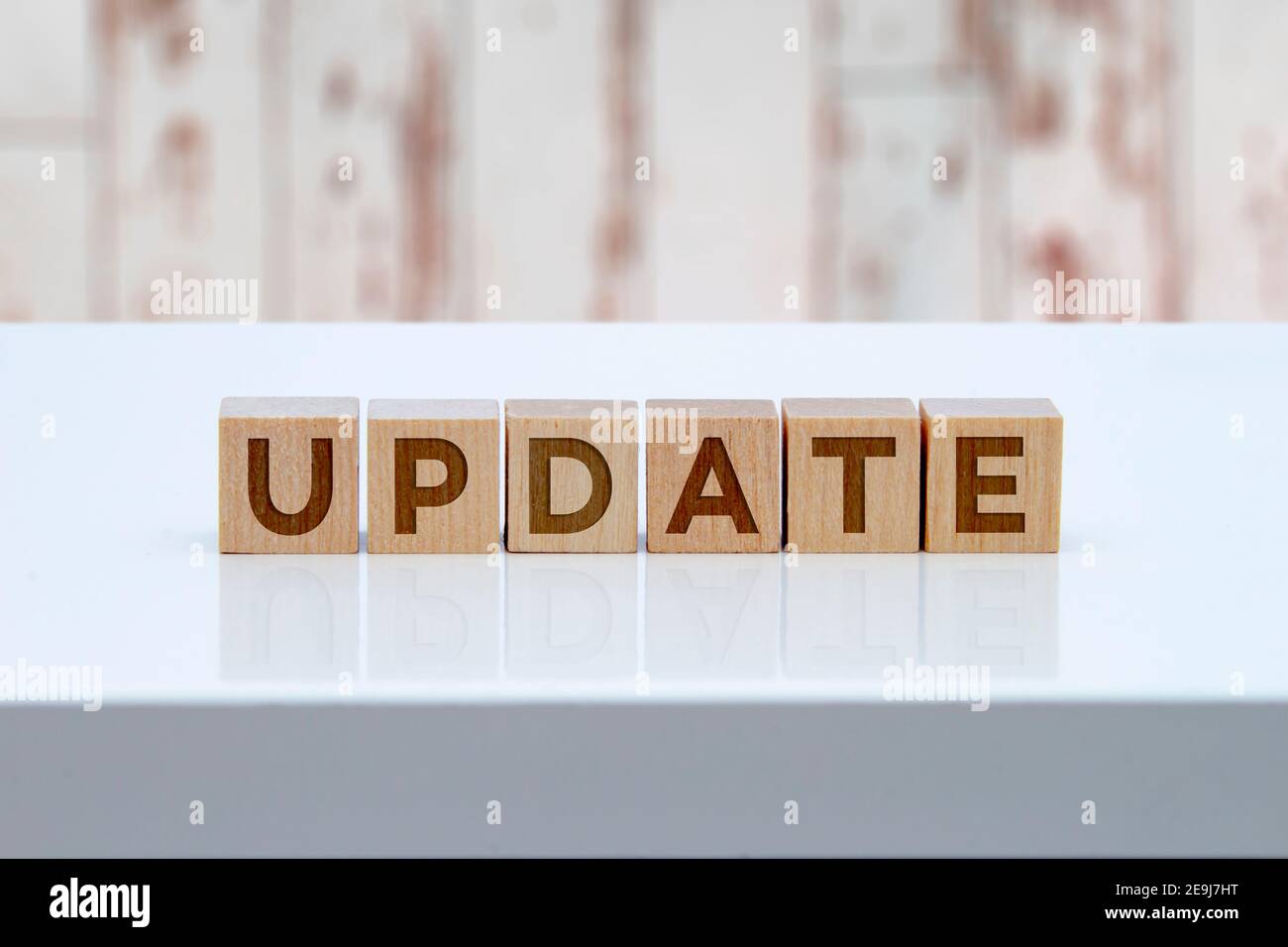 'Update' message sign on wooden blocks sitting on a white table with ...