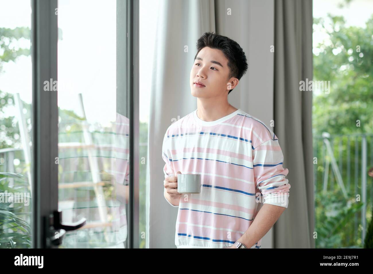 Smiling from window hi-res stock photography and images - Alamy