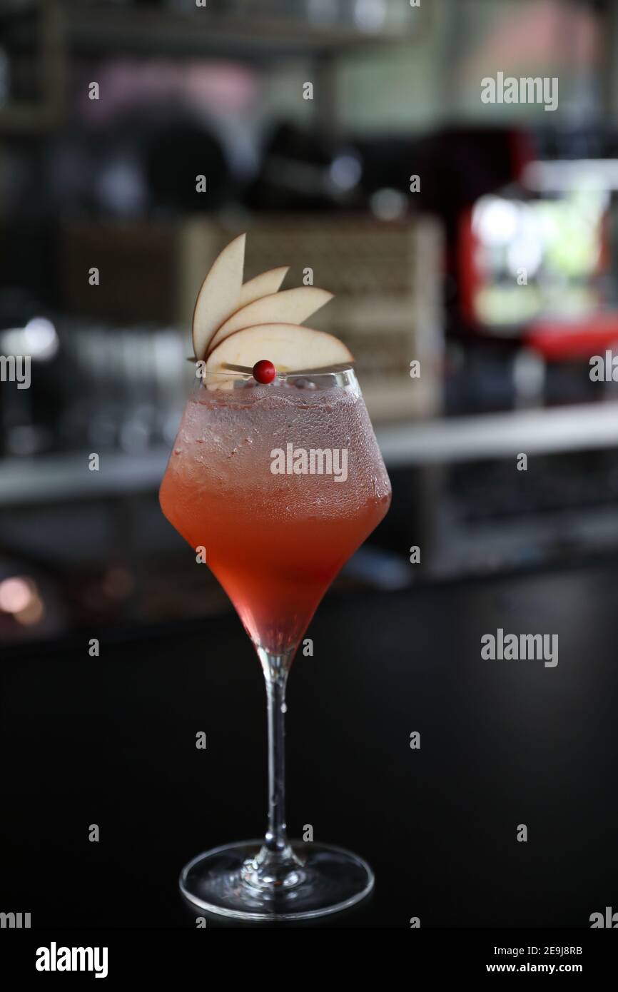 Pink Cocktail glass with ice at a bar counter Stock Photo - Alamy