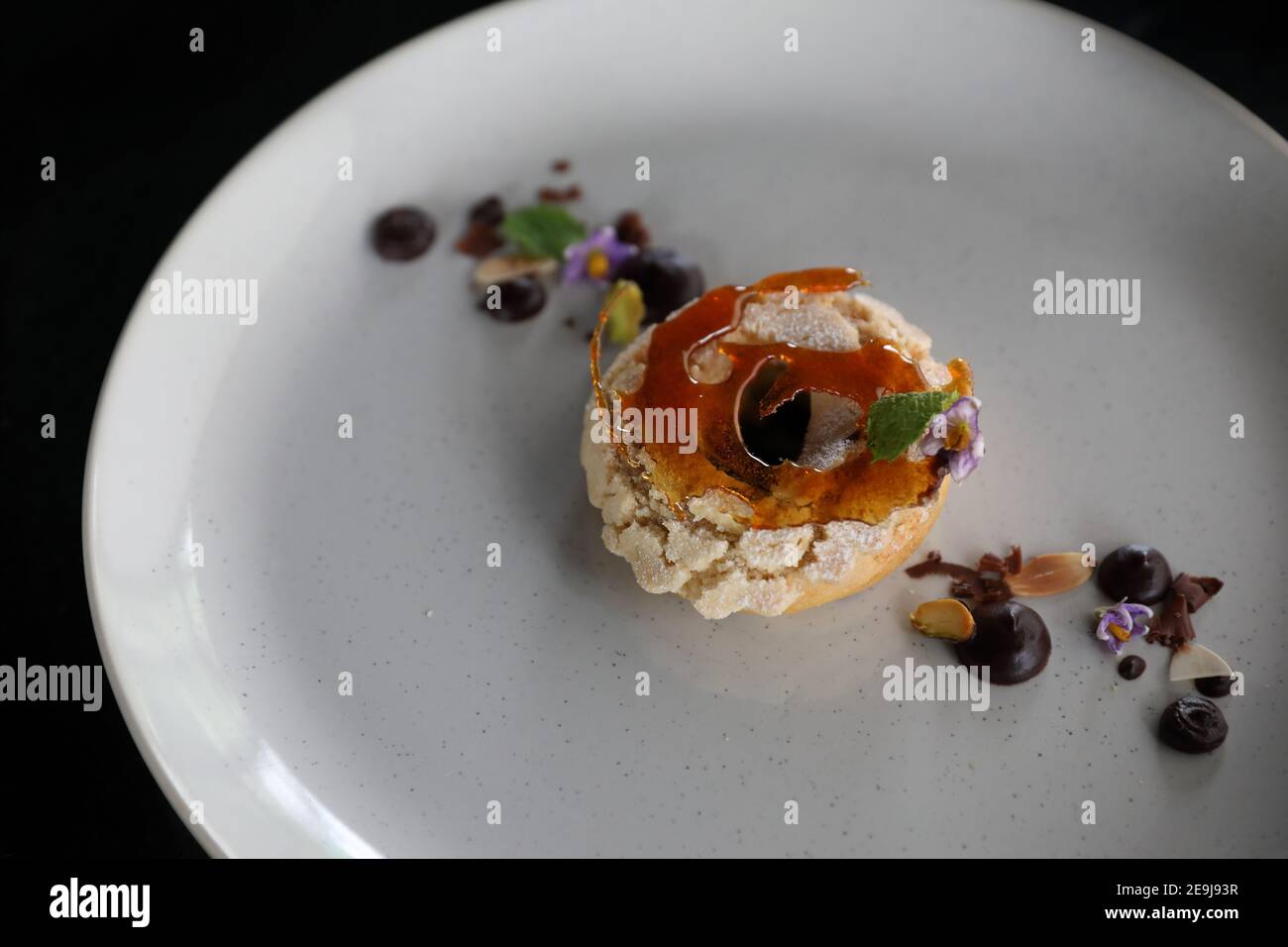 Chocolate dessert cake with berry sauce and almond with decorated Stock ...