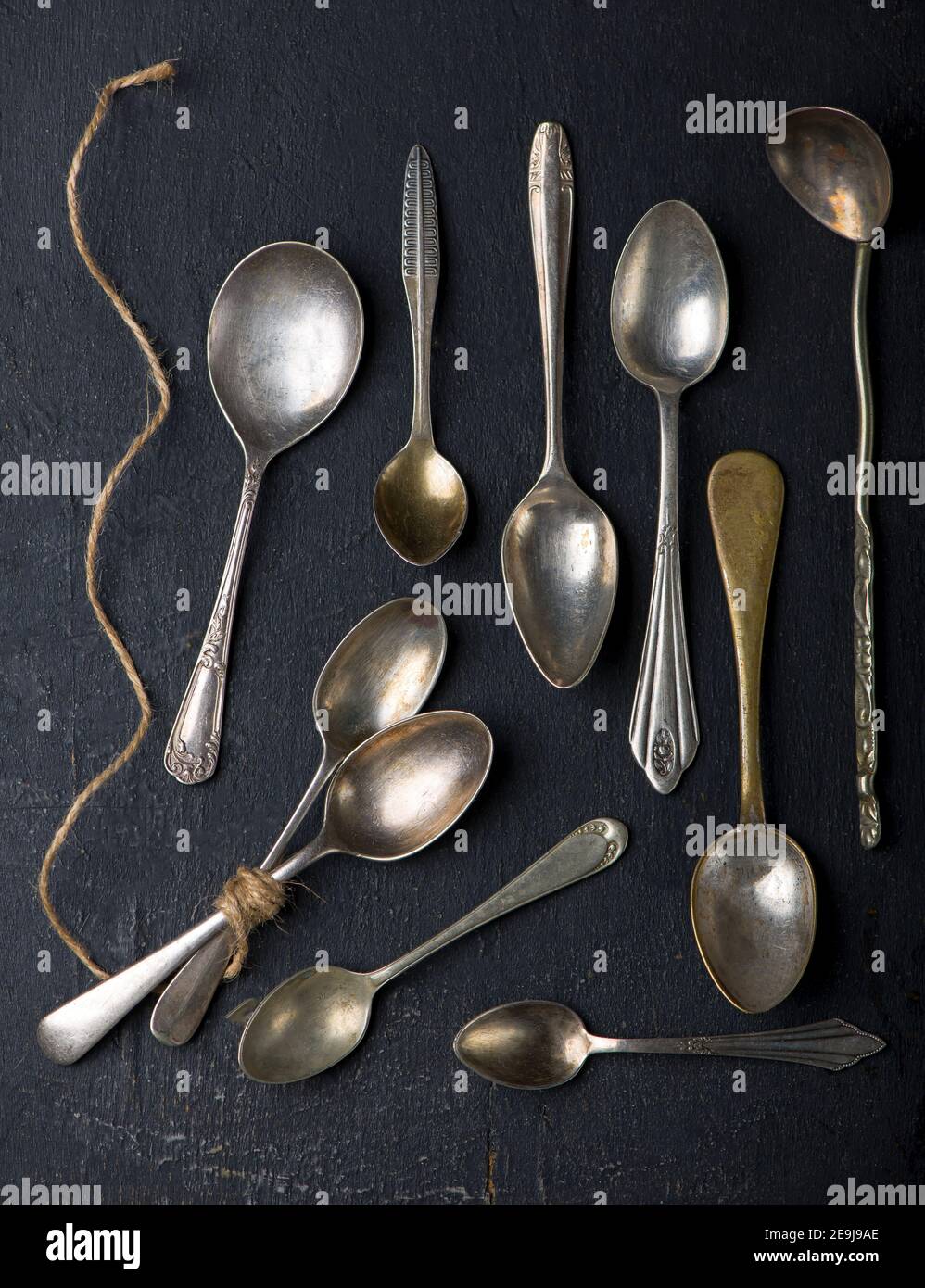Flat lay. Placed on a black background empty wooden spoon, five pieces ...