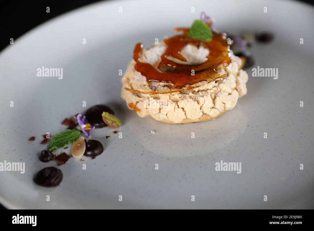 Chocolate dessert cake with berry sauce and almond with decorated Stock ...