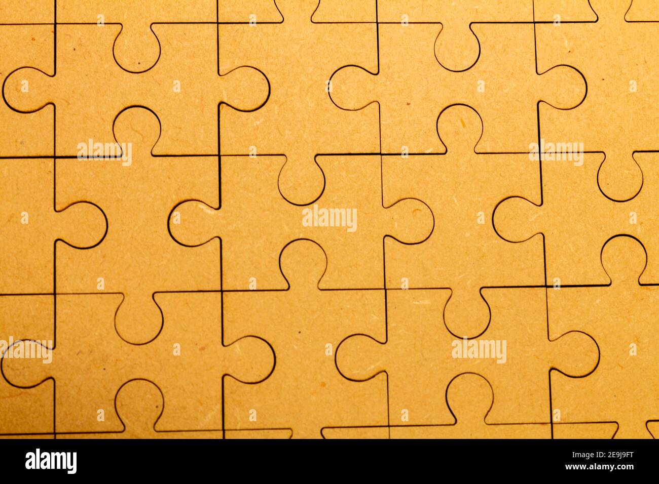 Tow view picture of a partial view of a brown puzzle. Jigsaw as a ...