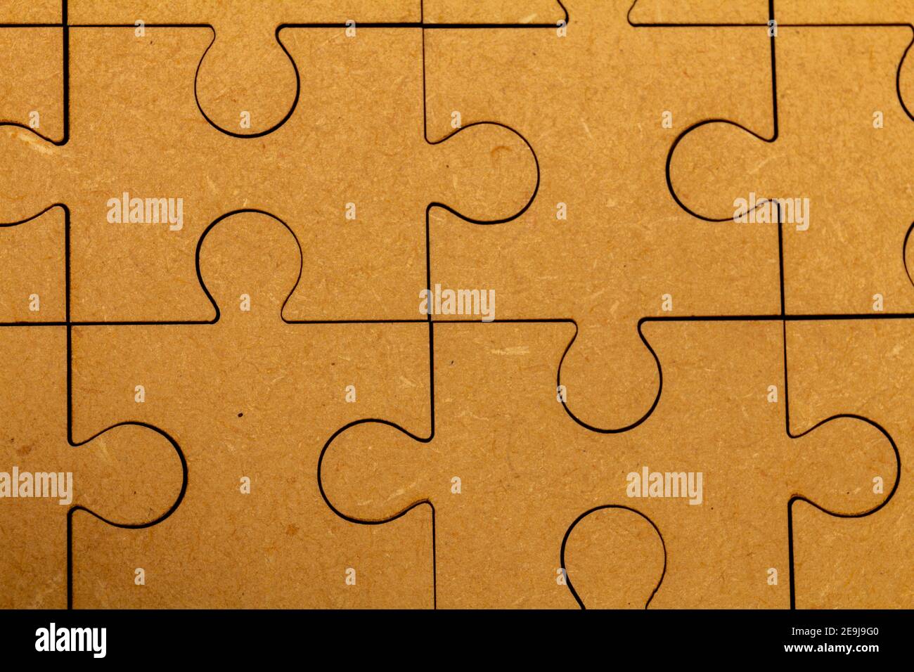 Tow view picture of a partial view of a brown puzzle. Jigsaw as a ...