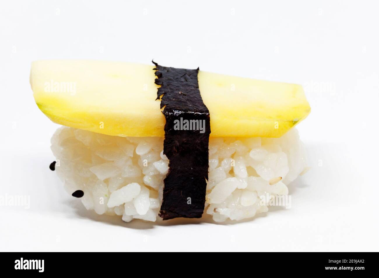 a sushi piece with yellow radish on white background Stock Photo - Alamy