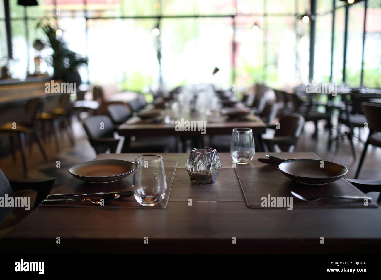 Table set with silverware dish and glass in restaurant Stock Photo - Alamy