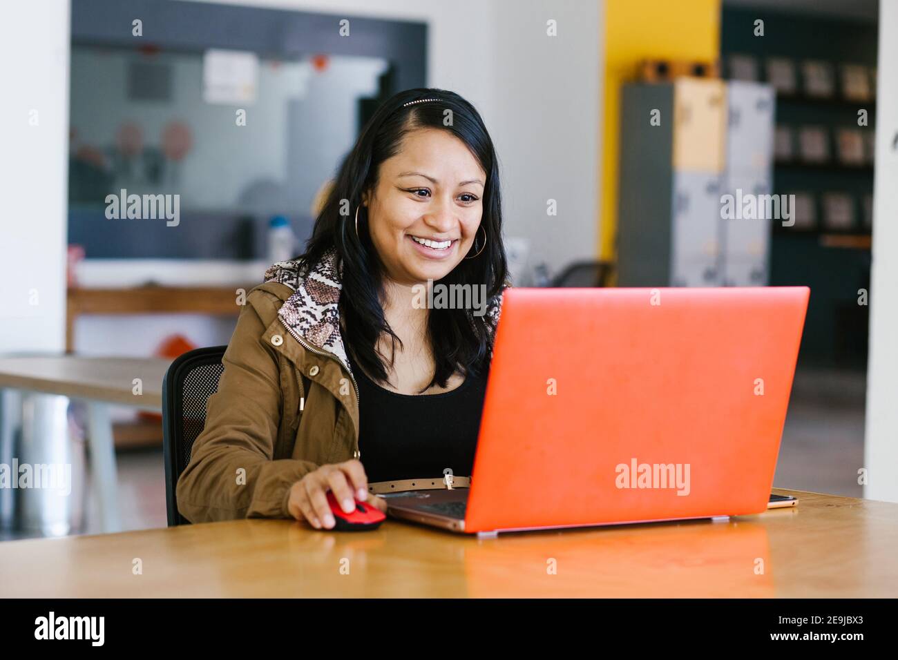 latin business woman working with computer at the office in Mexico city ...
