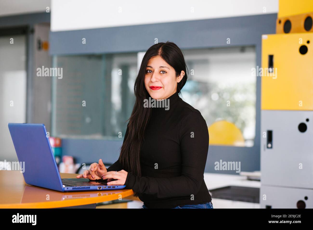 latin business woman working with computer at the office in Mexico city ...