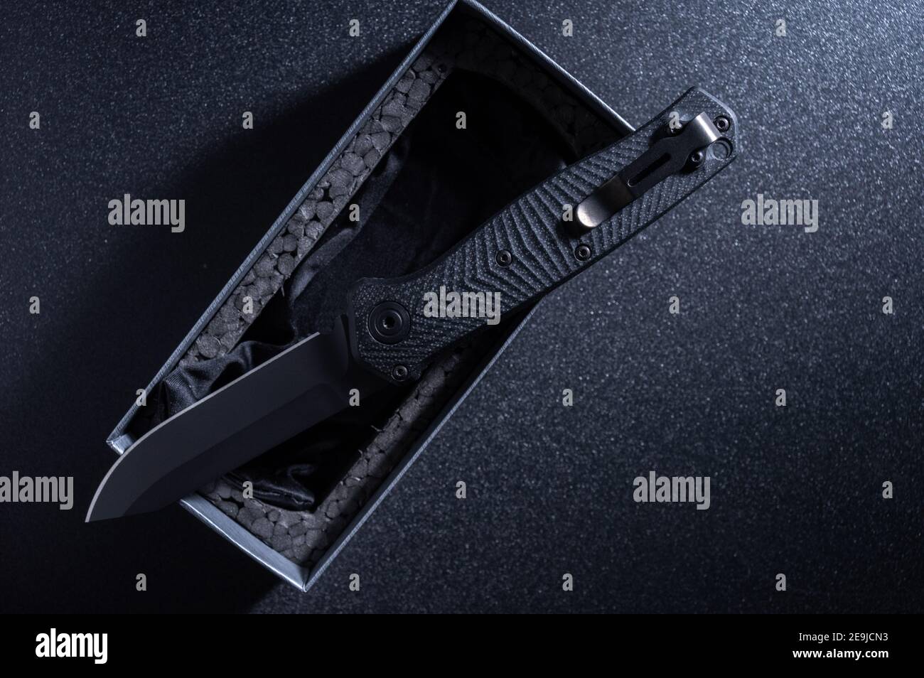 Knife in a cardboard box. New pocket knife in a box. Folding knife with ...