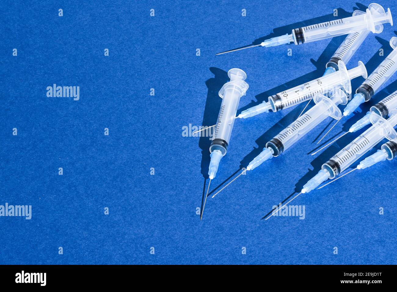 Group of disposable medical syringes for injections on blue Stock Photo ...