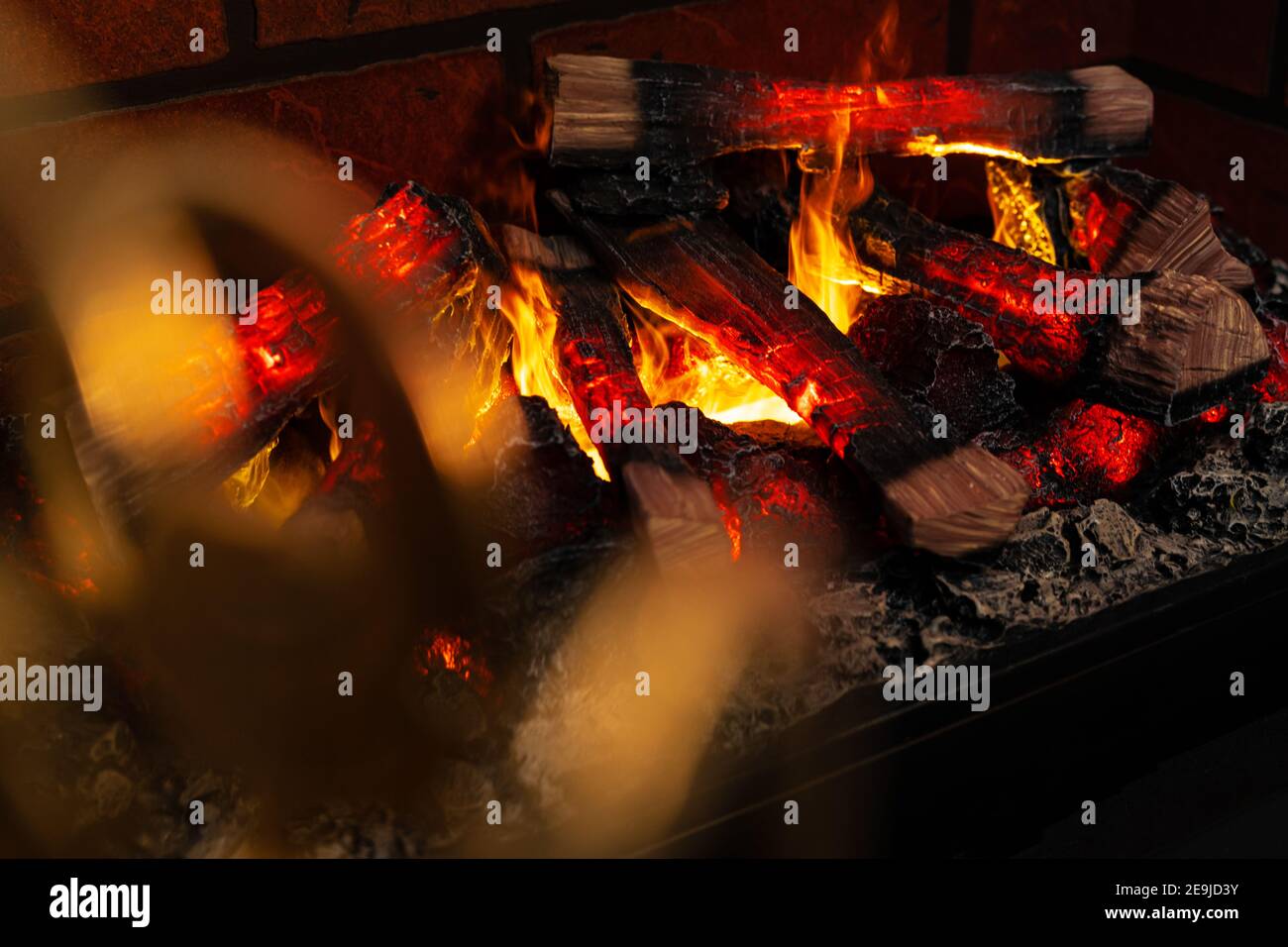 Close up of a fireplace with burning wood logs inside Stock Photo - Alamy