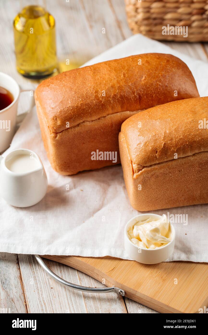 Loafs of white brick shaped bread with butter Stock Photo - Alamy