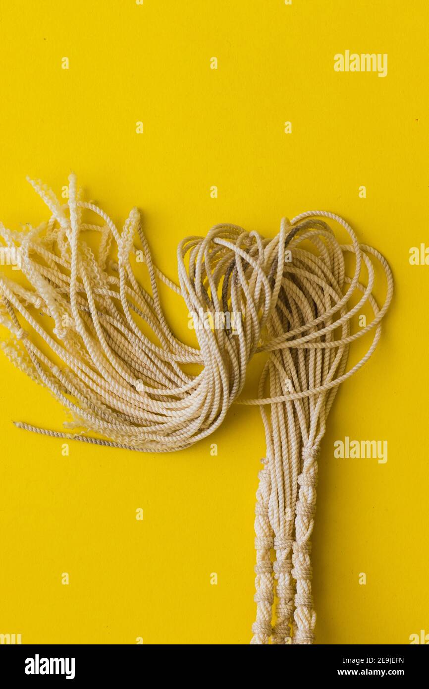 Tallit threads made of sheep wool, yellow background Stock Photo - Alamy