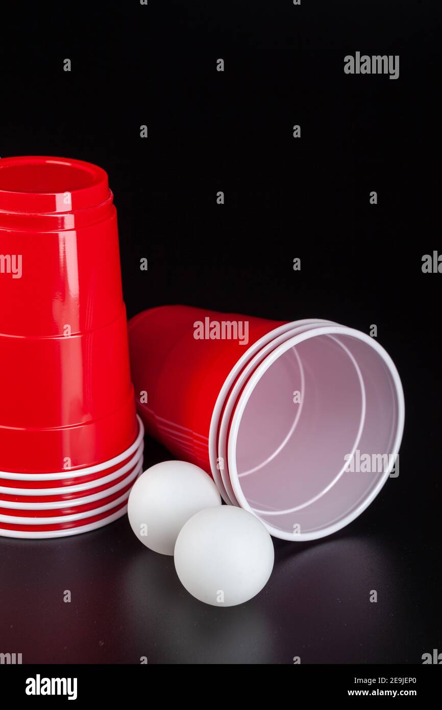 Red plastic cups and ball for game of beer pong Stock Photo - Alamy