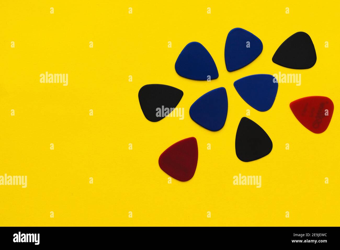Guitar picks are placed on a yellow background Stock Photo - Alamy