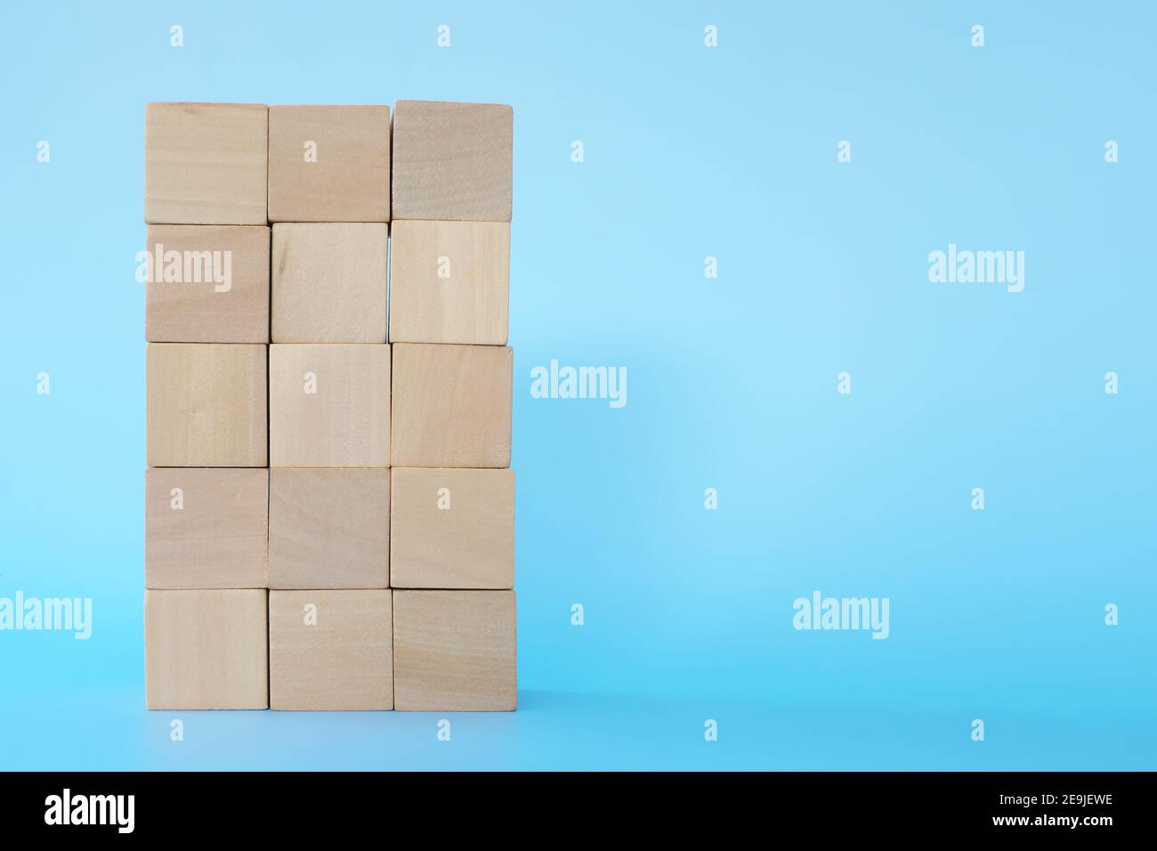 Building blocks tower in blue background with copy space. Stability ...