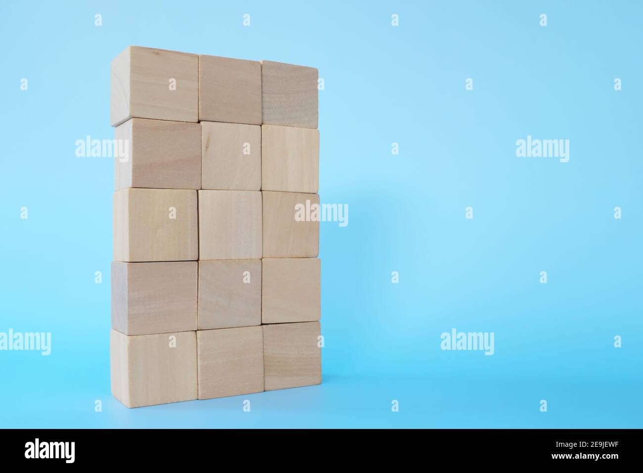 Building blocks tower in blue background with copy space. Stability ...