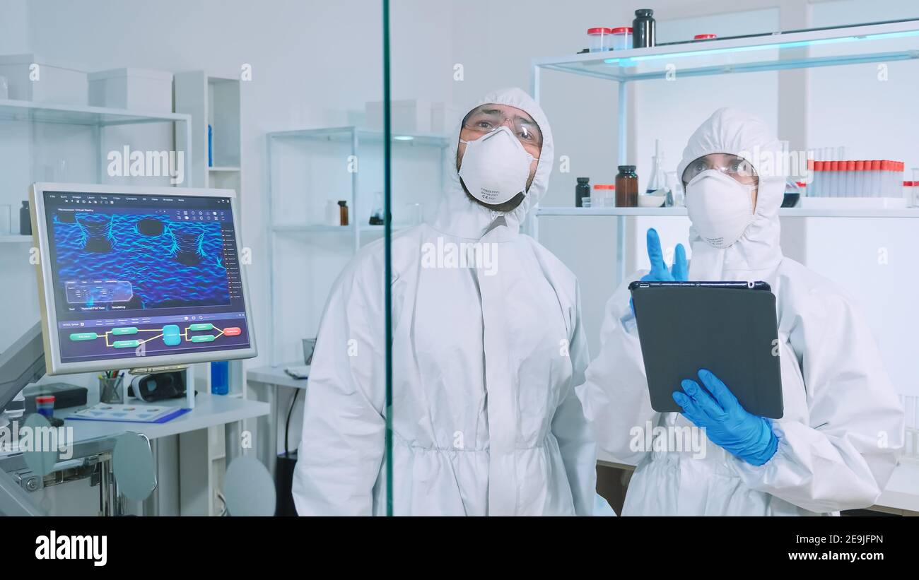 Team of scientists in ppe suit working in chemistry modern equipped ...