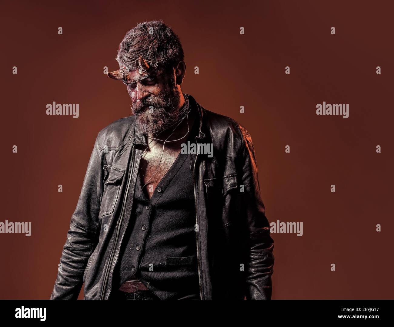 Halloween hell, danger. Demon with beard, wounds, red blood on brown ...