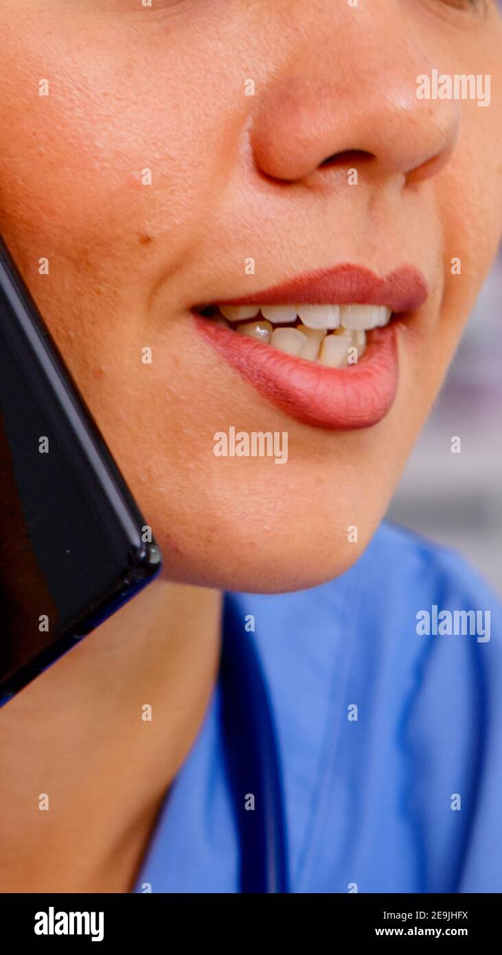 Healthcare physician consulting remote patients using phone in hospital ...
