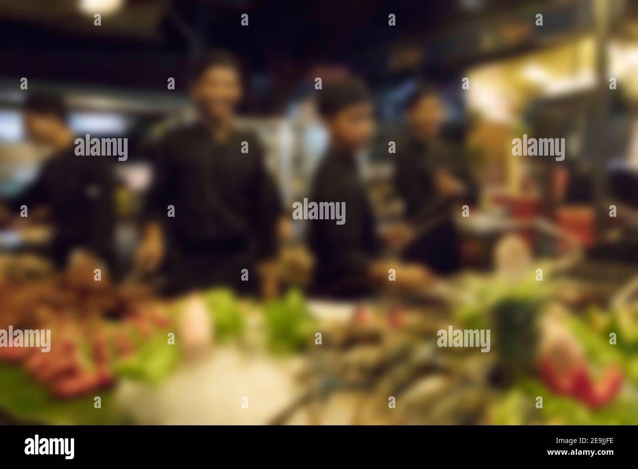 Restaurant blurred photo for background. A group of chefs prepares ...