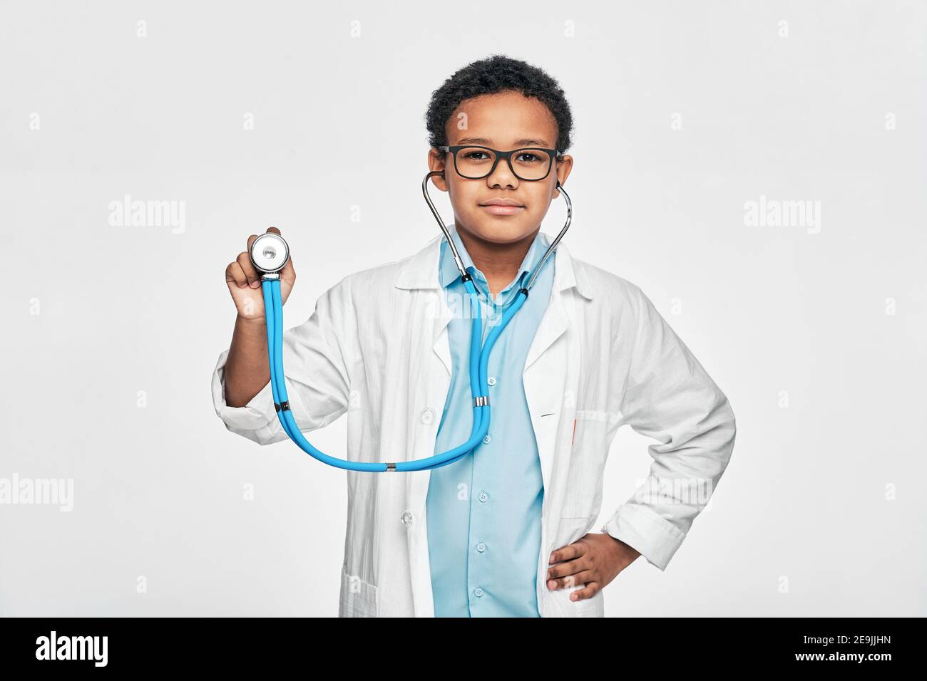 Portrait of African American male kid wearing a doctor coat with ...