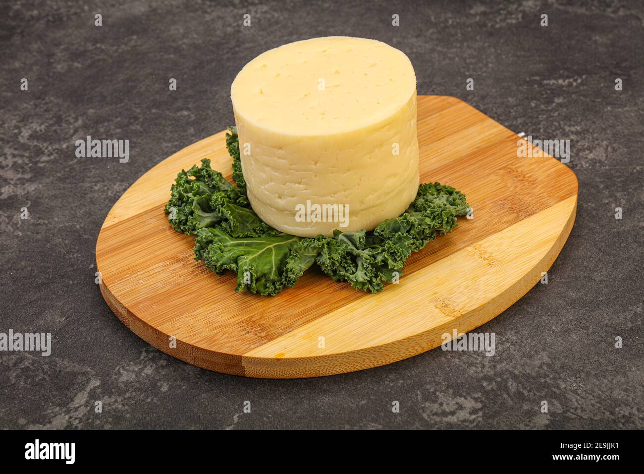 Yellow round dairy soft cheese piece Stock Photo - Alamy
