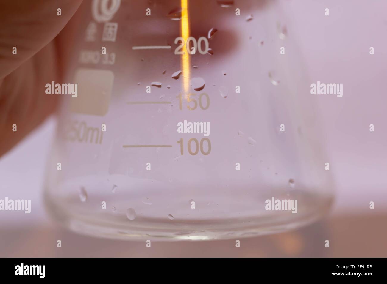 High resolution macro of a hand holding conical laboratory glass Stock ...