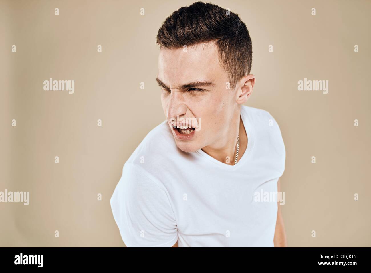 Man with displeased facial expression emotions white t-shirt gestures ...