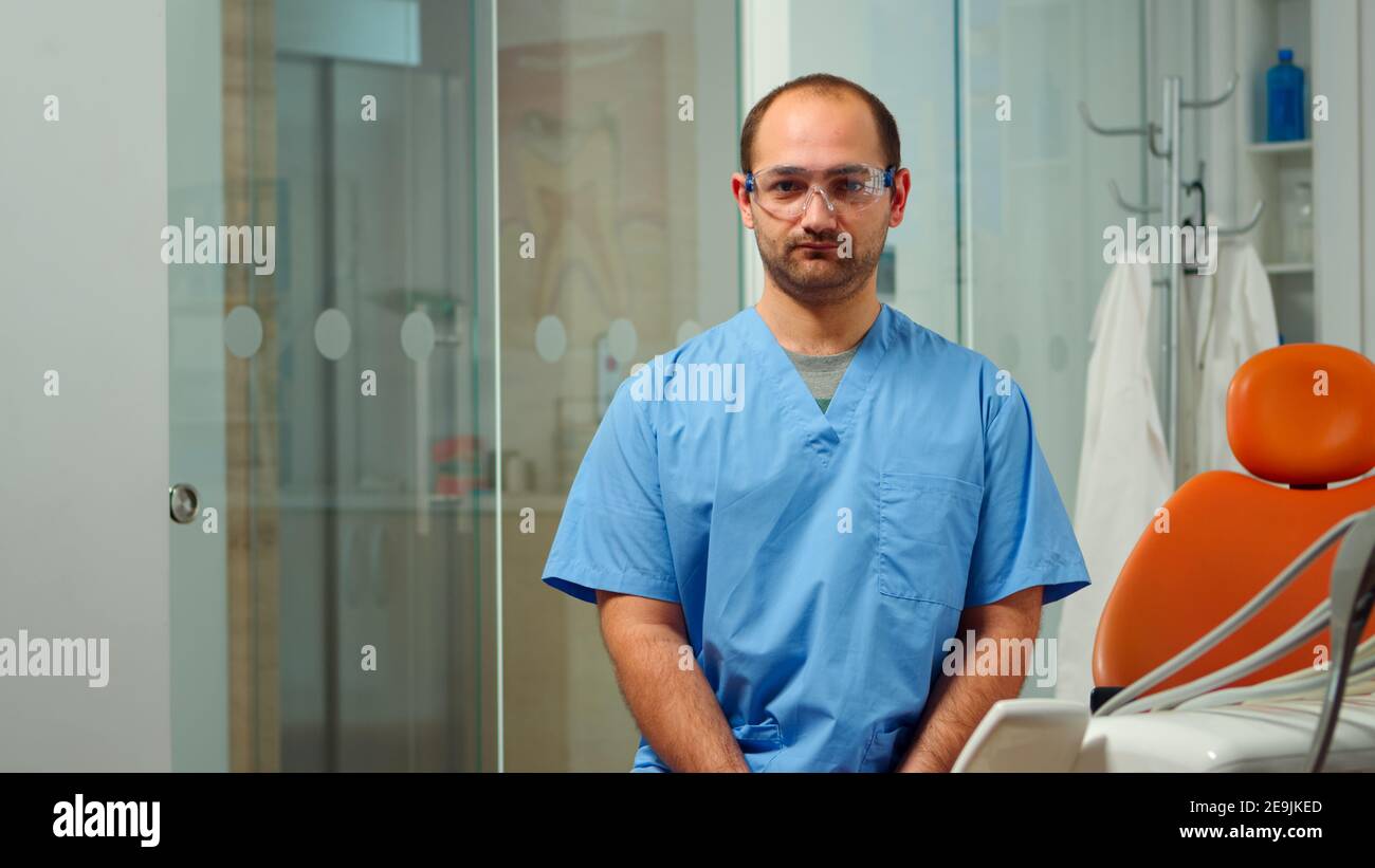 Dentist nurse looking at camera talking about dental hygiene ...