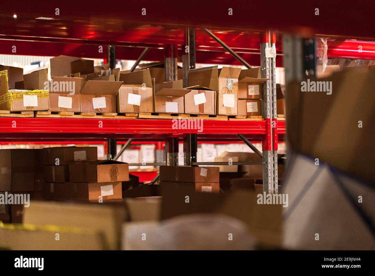 Modern warehouse shelves with pile of cardboard boxes Stock Photo - Alamy