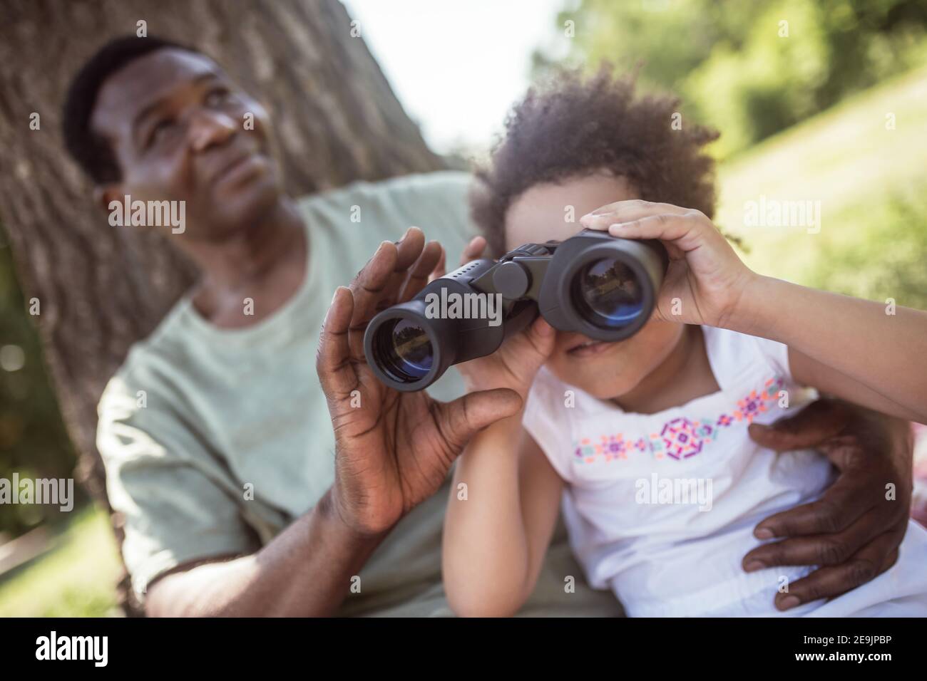 Child man binocular park hi-res stock photography and images - Alamy