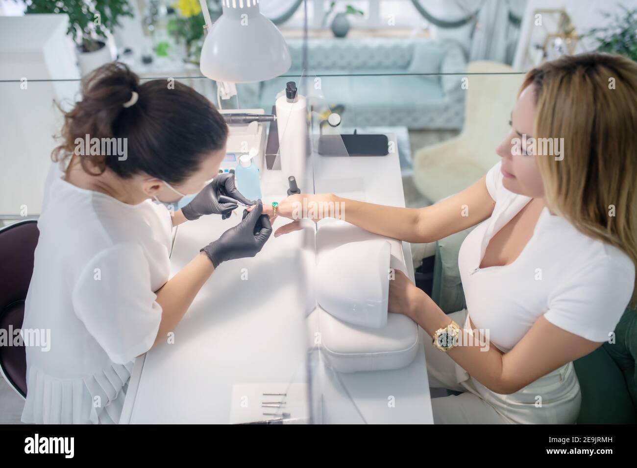 Female nail artist working with the client in a beauty salon Stock ...