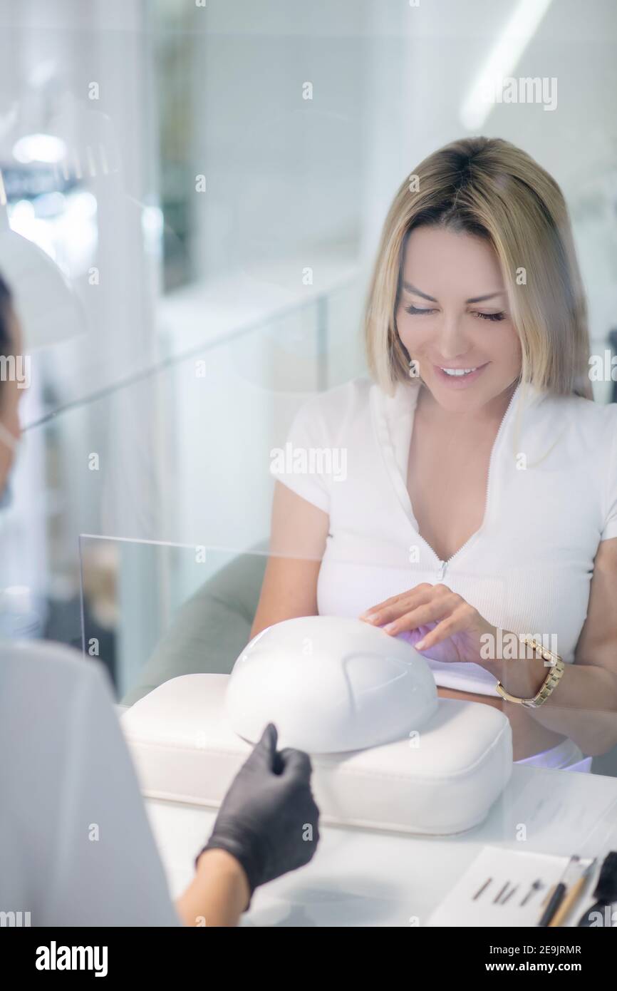 Female nail artist working with the client in a beauty salon Stock ...