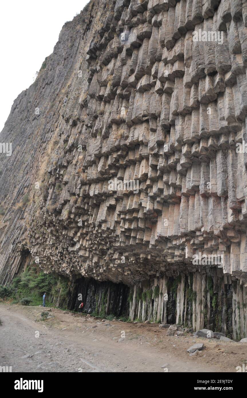 Mesmerizing view of man standing under Basalt Columns in Garni Gorge ...