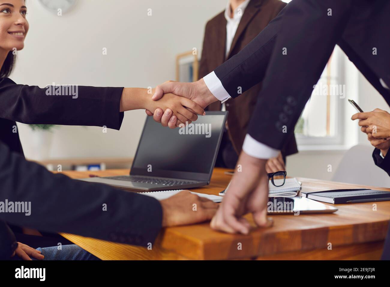 Business partners shaking hands after successful negotiations and ...
