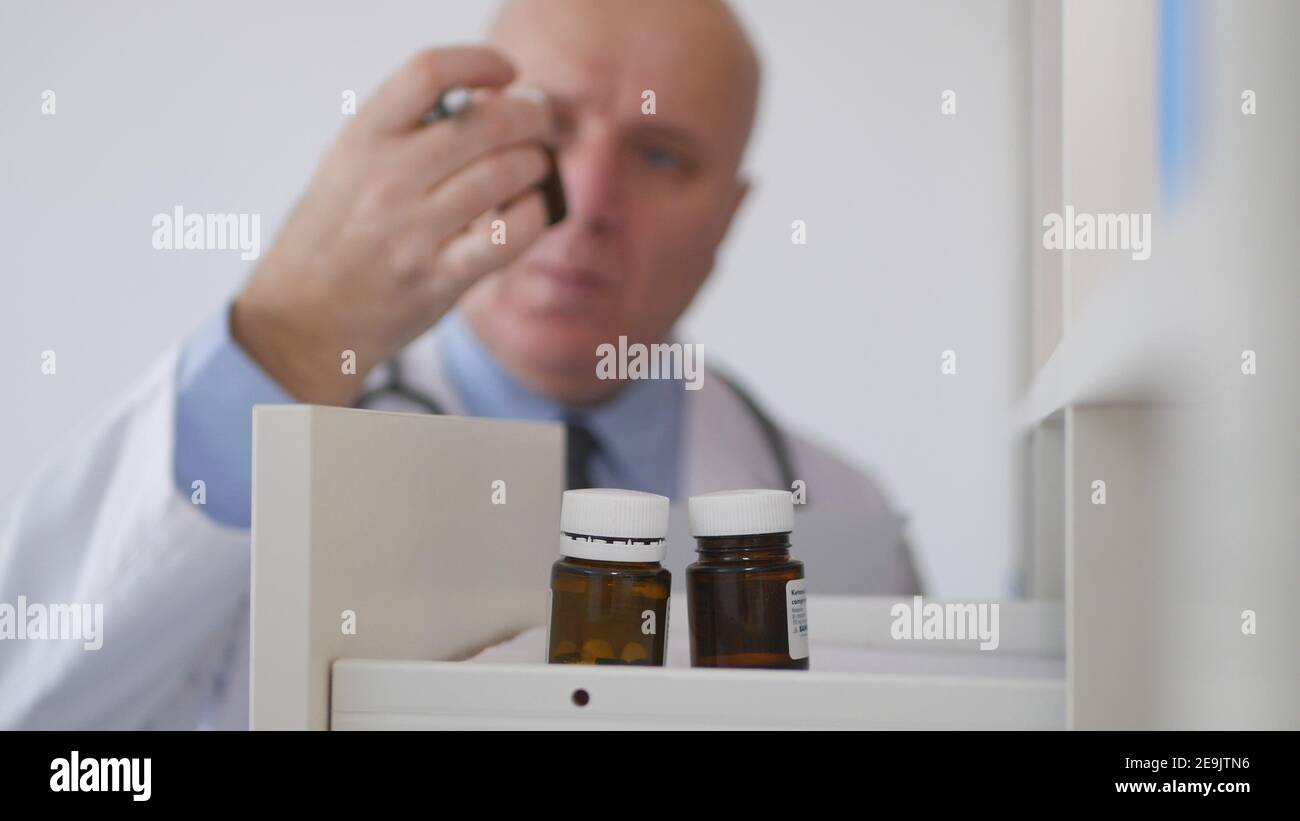 Doctor in Hospital Room Searching Medicaments, Pills and Drugs Stock ...