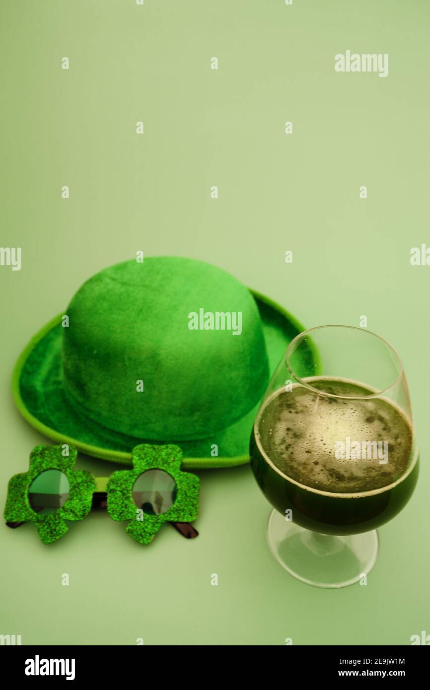 Happy St Patrick's Day concept. Glass of green beer. Party glasses and ...