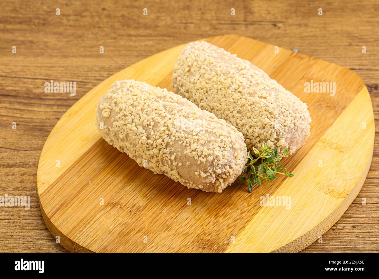 Raw breaded chicken cutlet for roast Stock Photo - Alamy