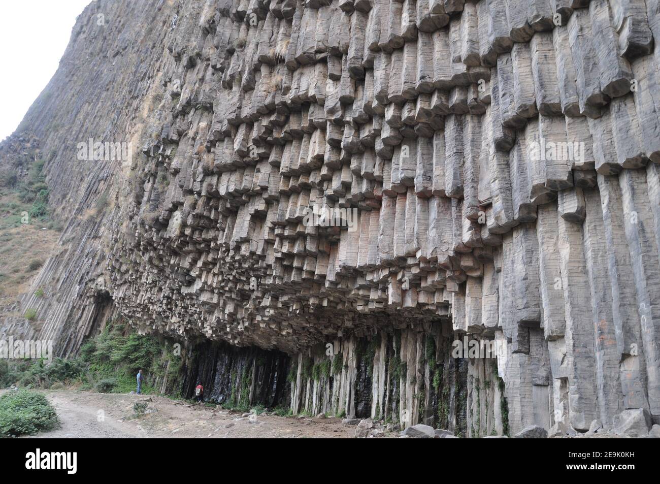 Mesmerizing view of man standing Basalt Columns in Garni Gorge, Armenia ...