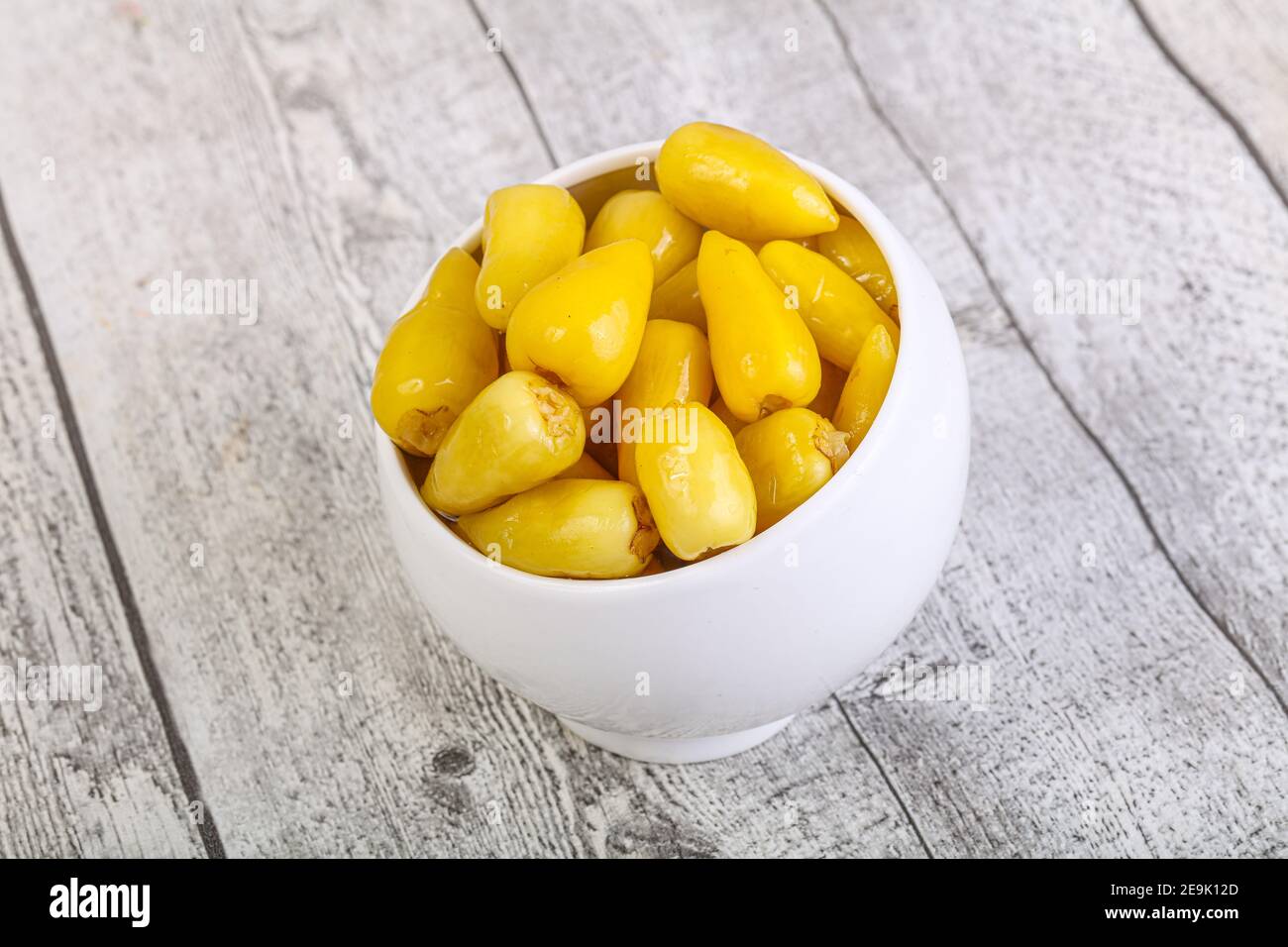 Pickled Yellow spicy mini pepper in the bowl Stock Photo - Alamy