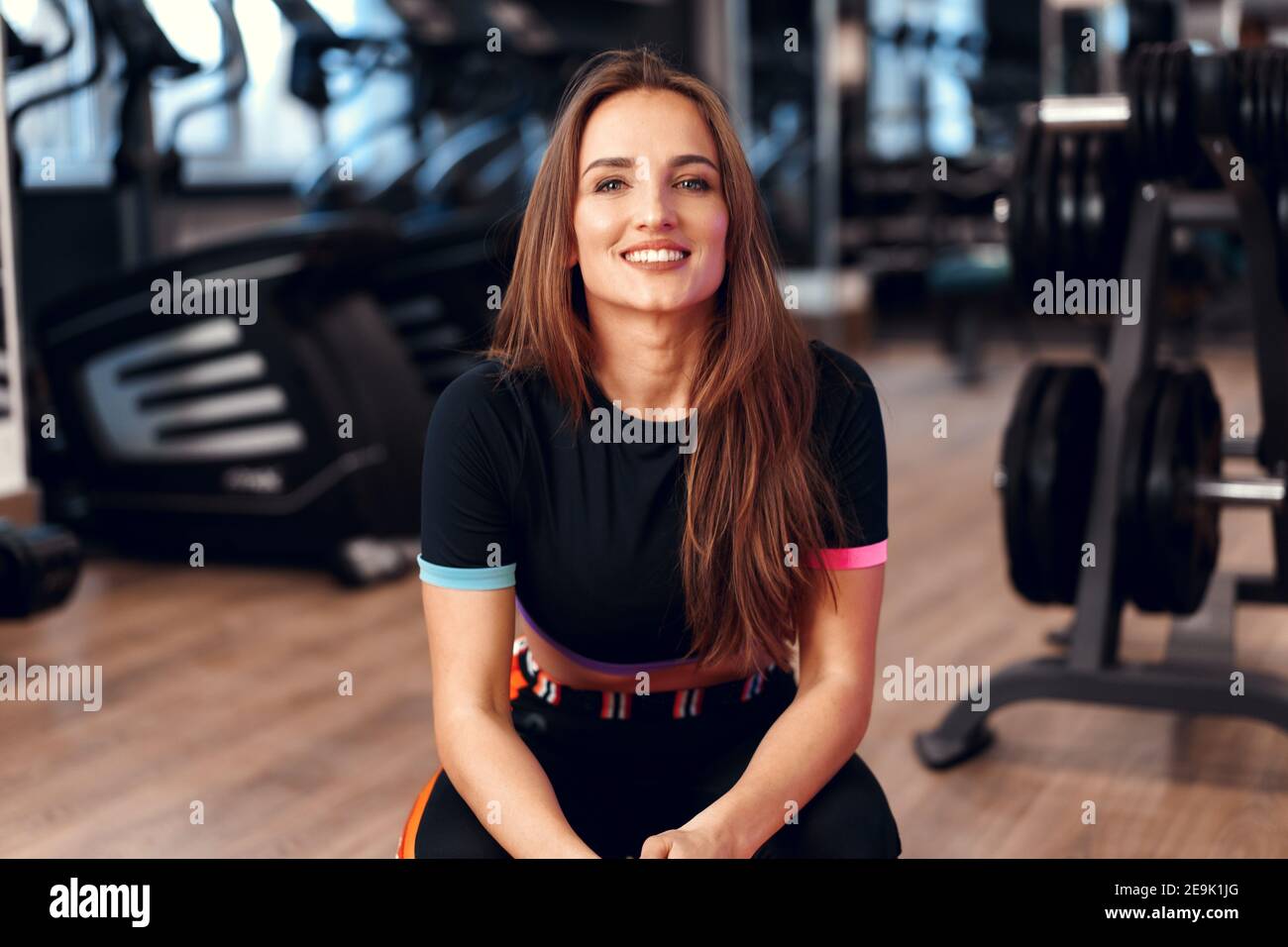 Woman fitness trainer portrait on a gym background Stock Photo - Alamy
