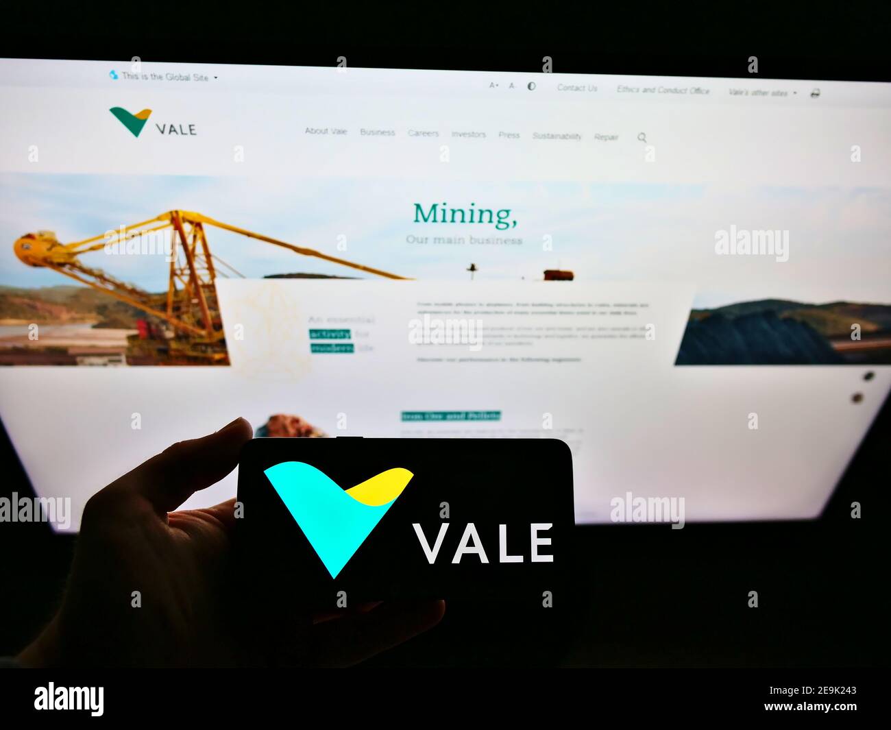 Person holding smartphone with logo of Brazilian mining and logistics ...