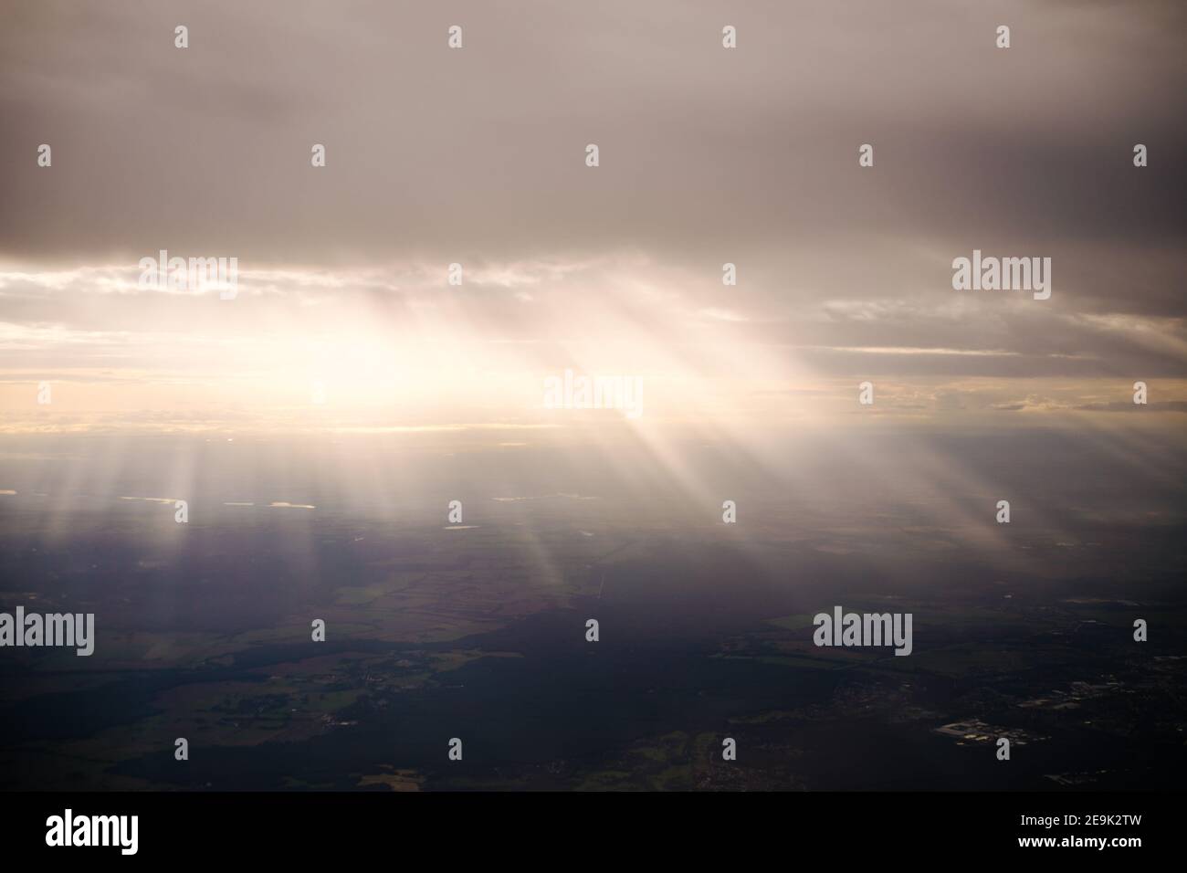 beams of sun light through the clouds on the hills Stock Photo - Alamy