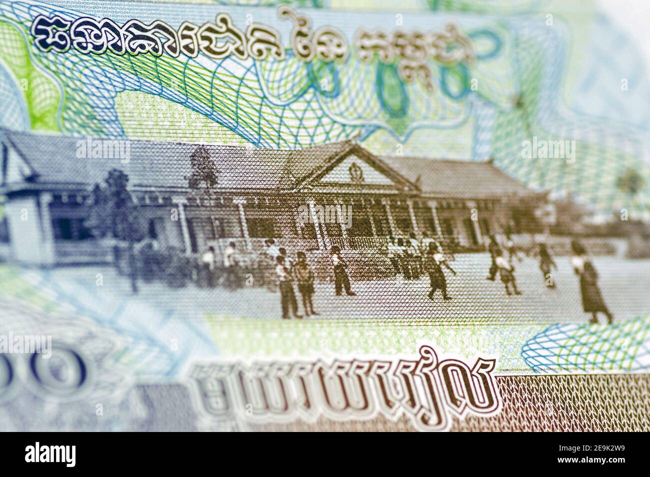 Detail of a 100 Riel banknote from Cambodia showing pupils heading into ...