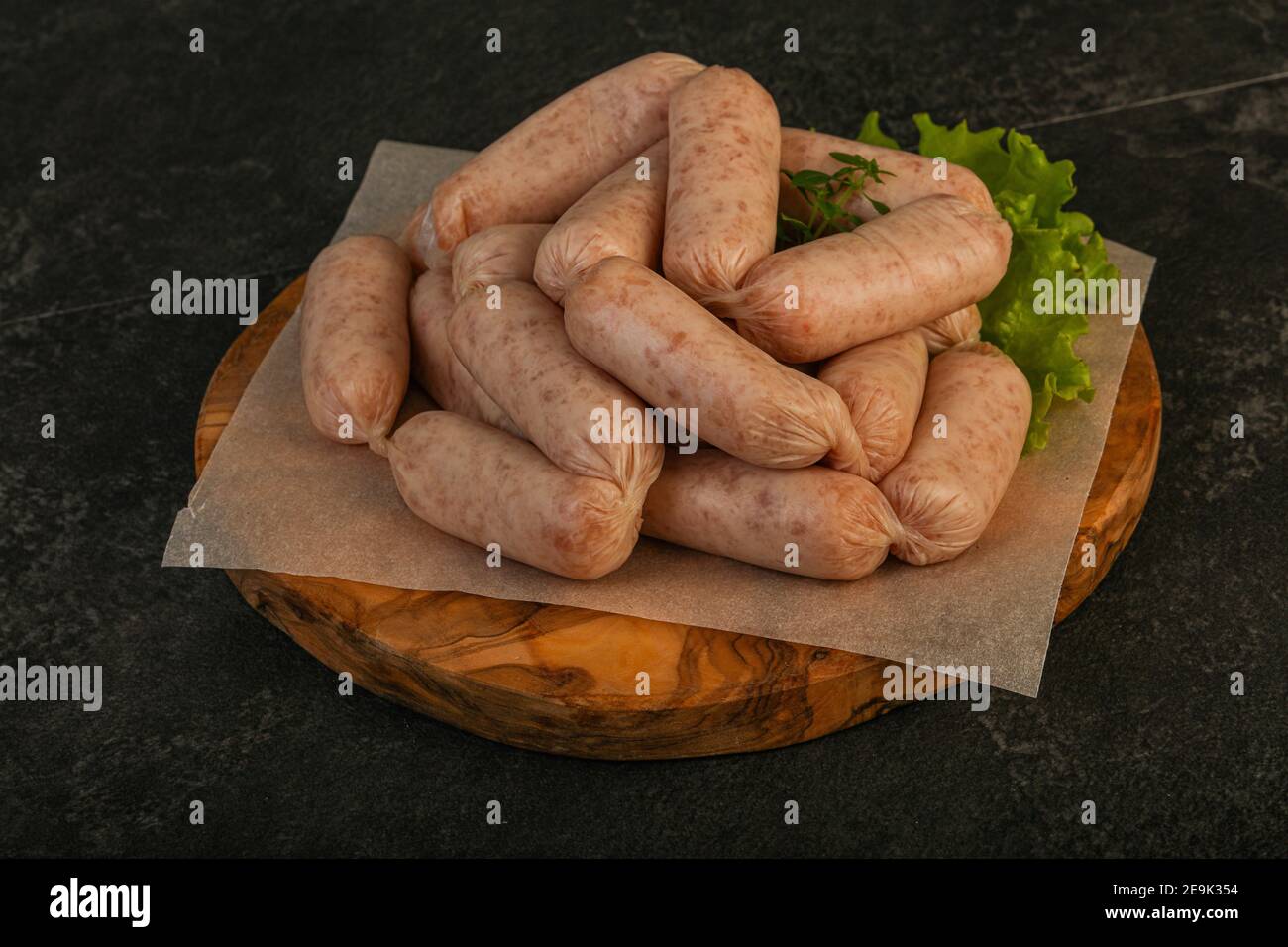Raw natural chicken baby sausages for roast Stock Photo - Alamy