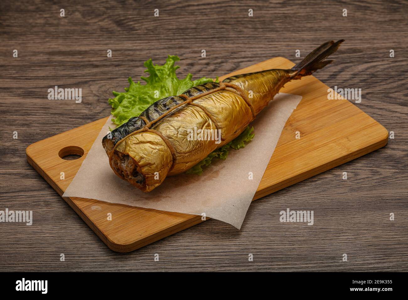 Smoked tasty mackerel fish snack over board Stock Photo - Alamy