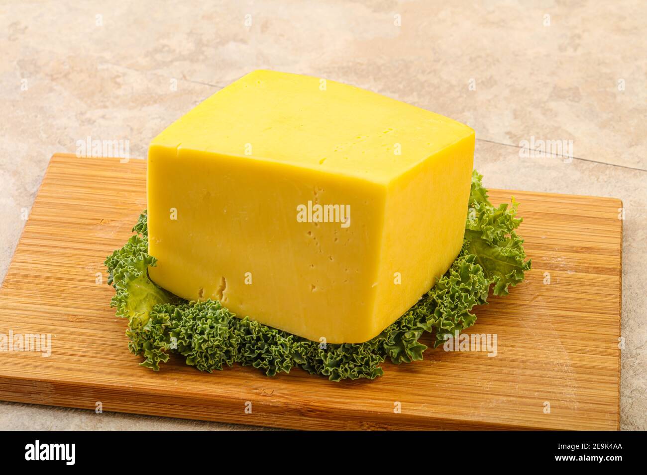 Yellow tilsiter cheese dairy product brick Stock Photo - Alamy